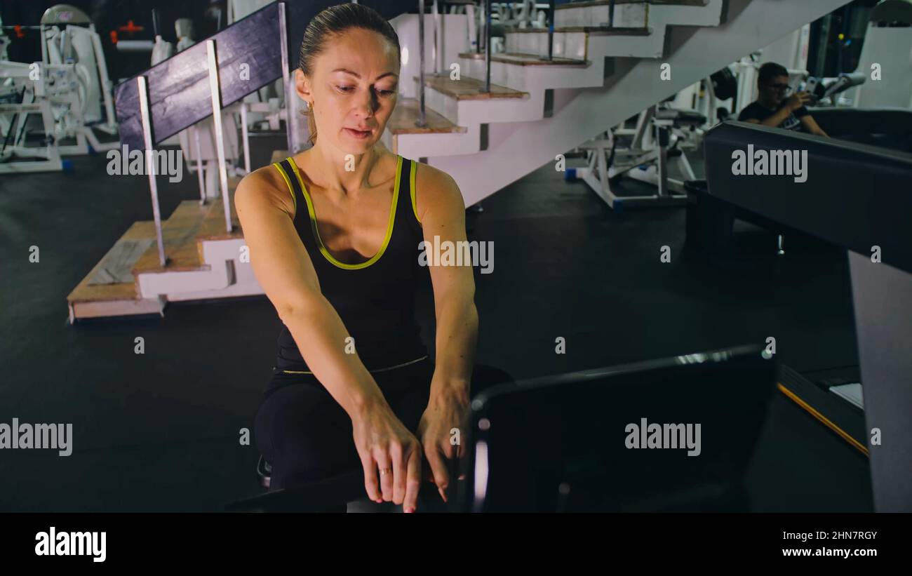 Fit Athletic Baby Woman Work out on Rowing Machine, Doing Her Fitness ...