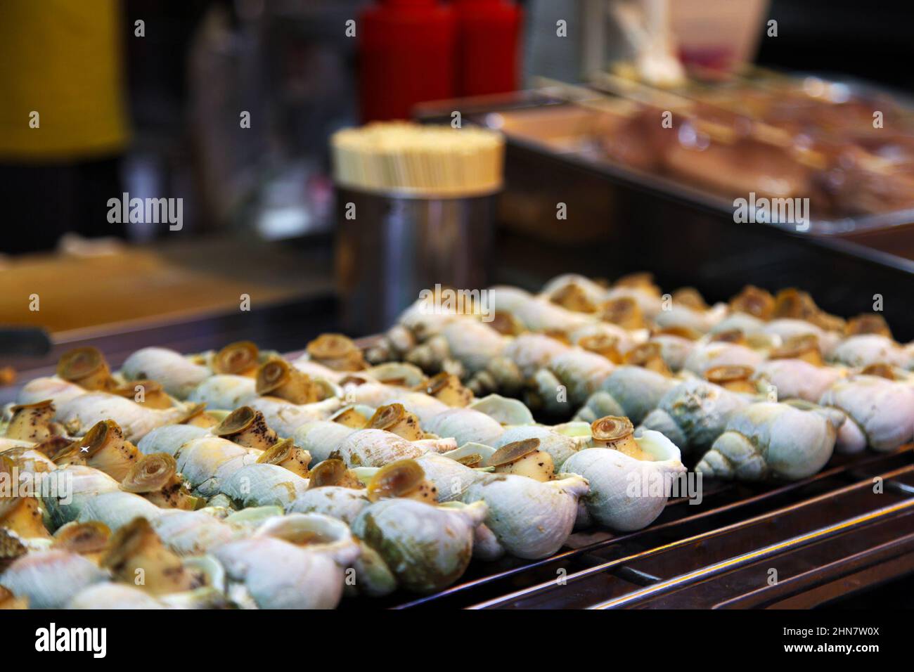 Street food grilled escargot snails served as snacks at outdoor Jiu Fen ...