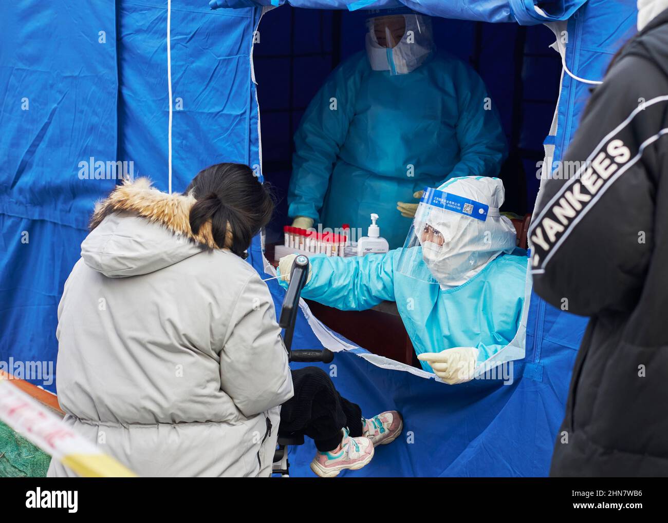A doctor is making the nucleic acid PCR test for a kid with a cotton ...