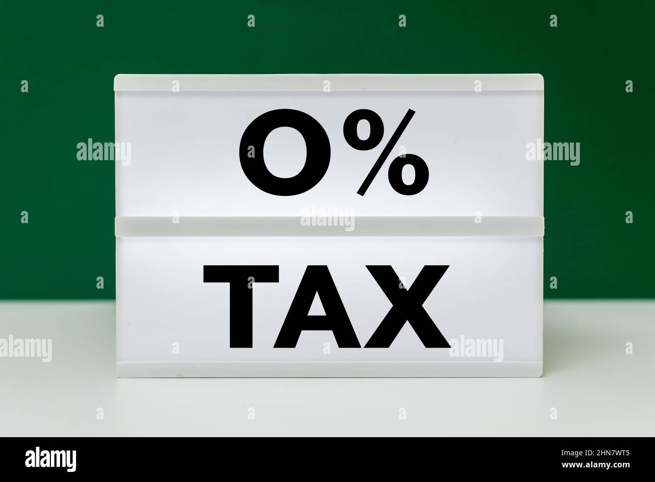 Zero percent tax on green background Stock Photo - Alamy