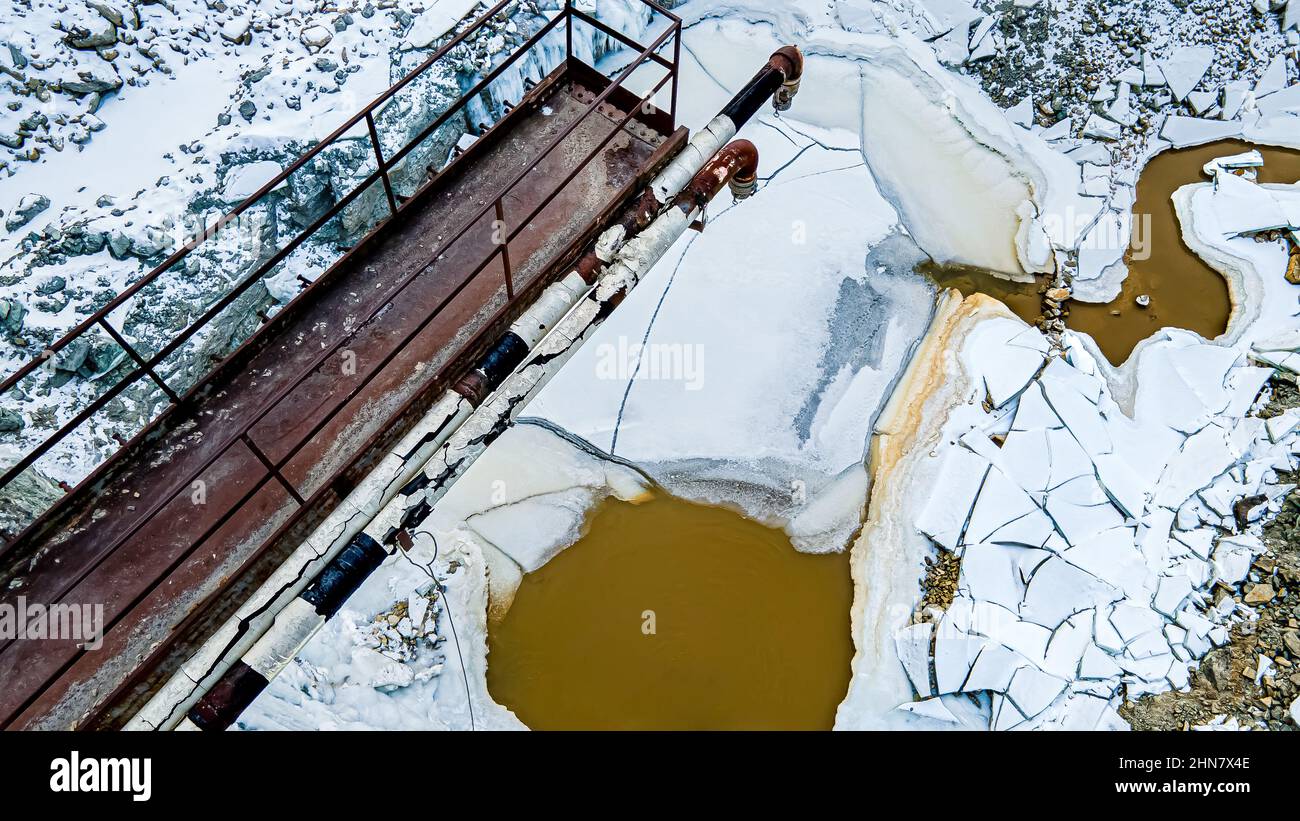 High view of a scary walkway over melting ice with a ice rider to a ...