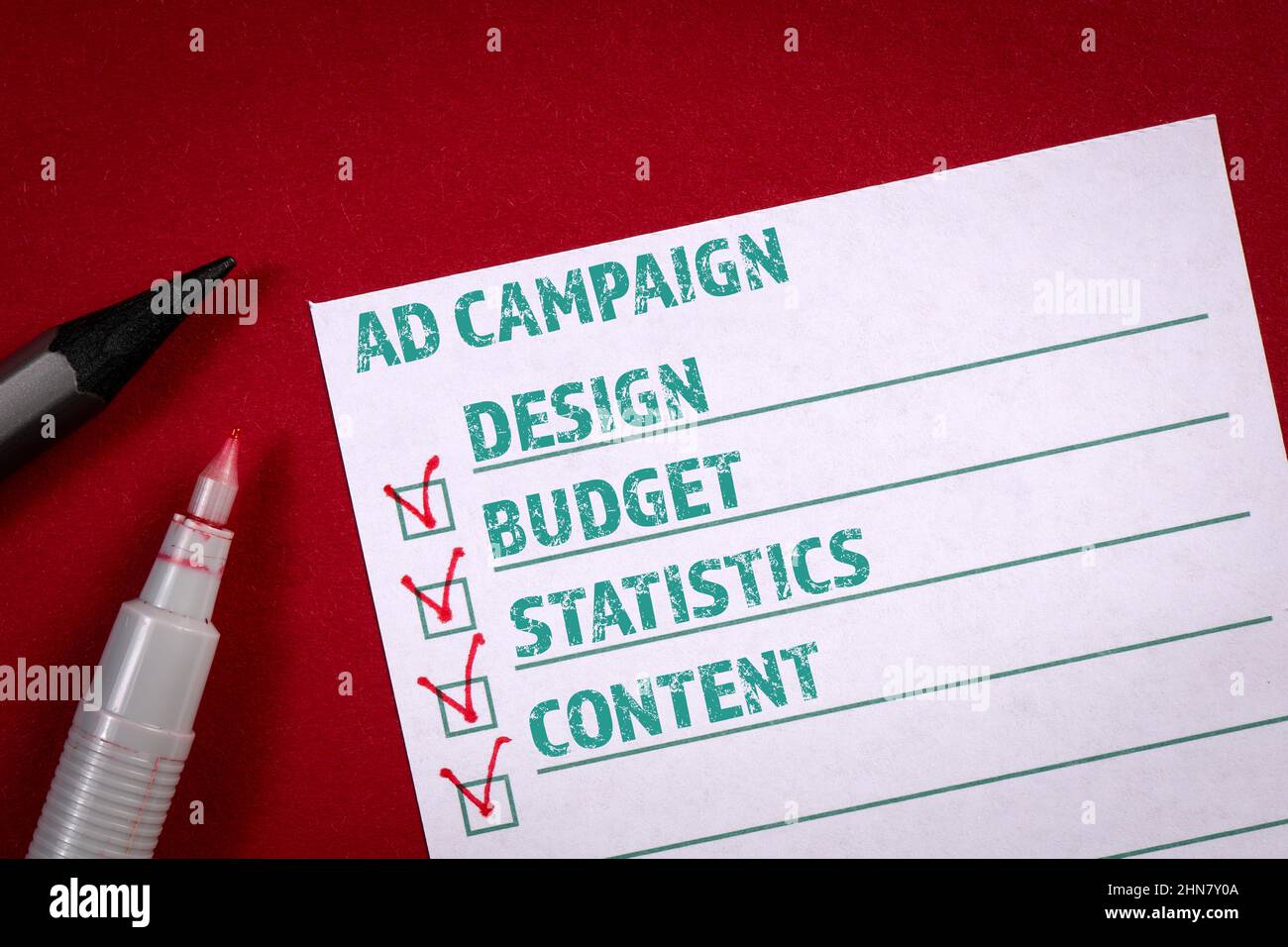 Ad Campaign checklist. Stationery and a sheet of paper on a red ...