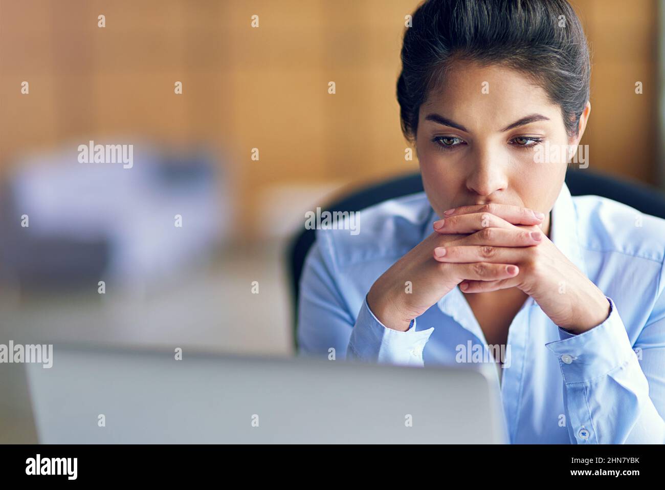 Its been a long day.... Shot of a young businesswoman looking stressed ...
