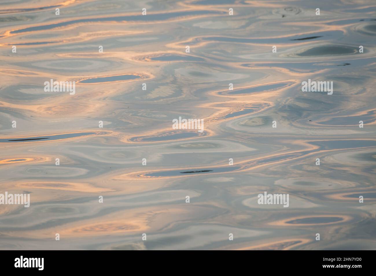 beautiful water wave pattern sunset and reflections background Stock ...