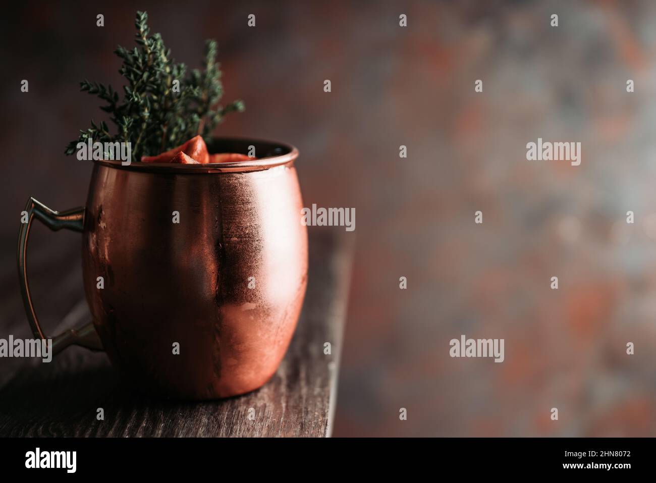 Red oranges cocktail in copper mug (variation of Moscow mule) on the ...
