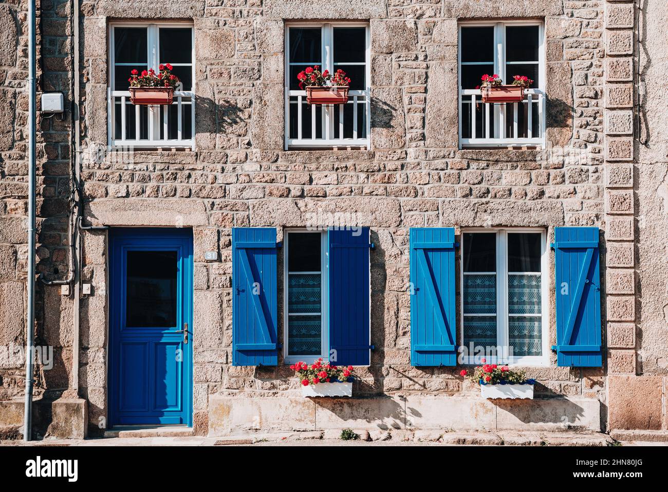 Windows with potted flowers of a stone house Stock Photo - Alamy