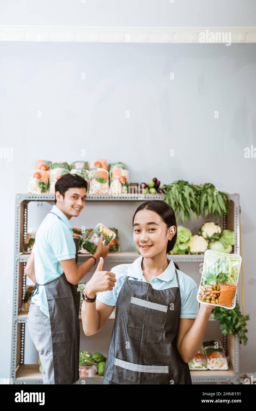 Two smiling vegetable sellers with thumbs up in vegetable stall Stock ...