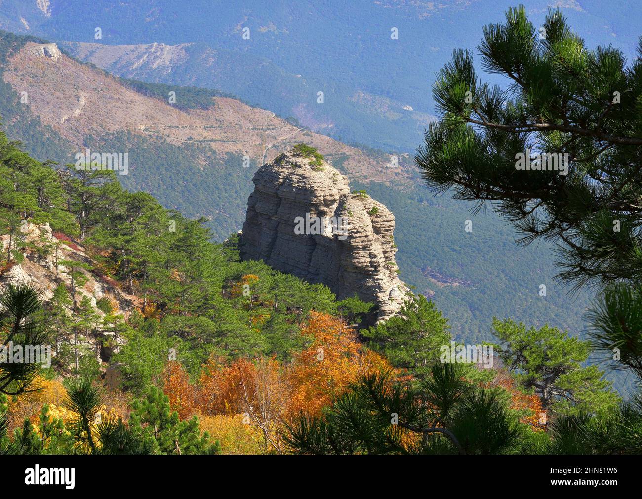 High rock-remnant with geological sedimentary layers in the mountains ...
