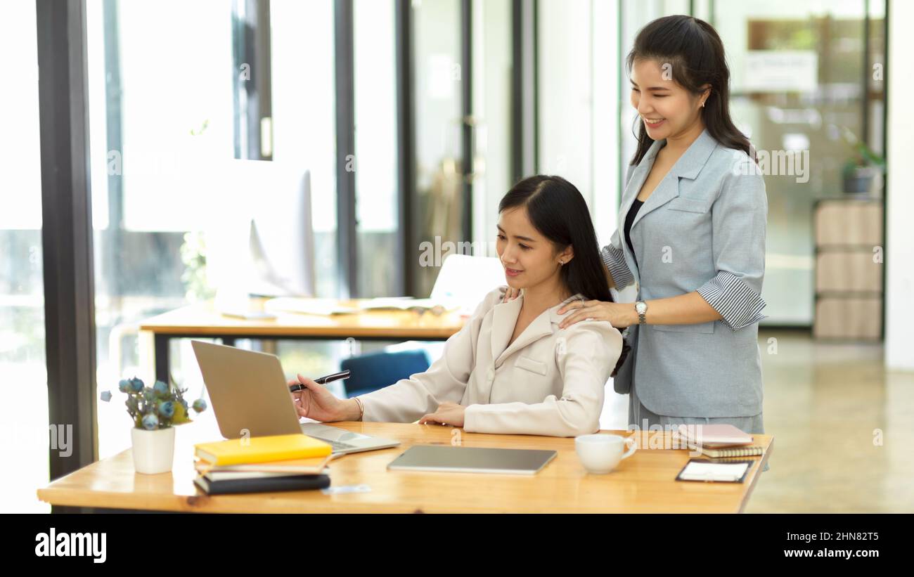 A beautiful supportive female colleague helping her colleague friend to ...