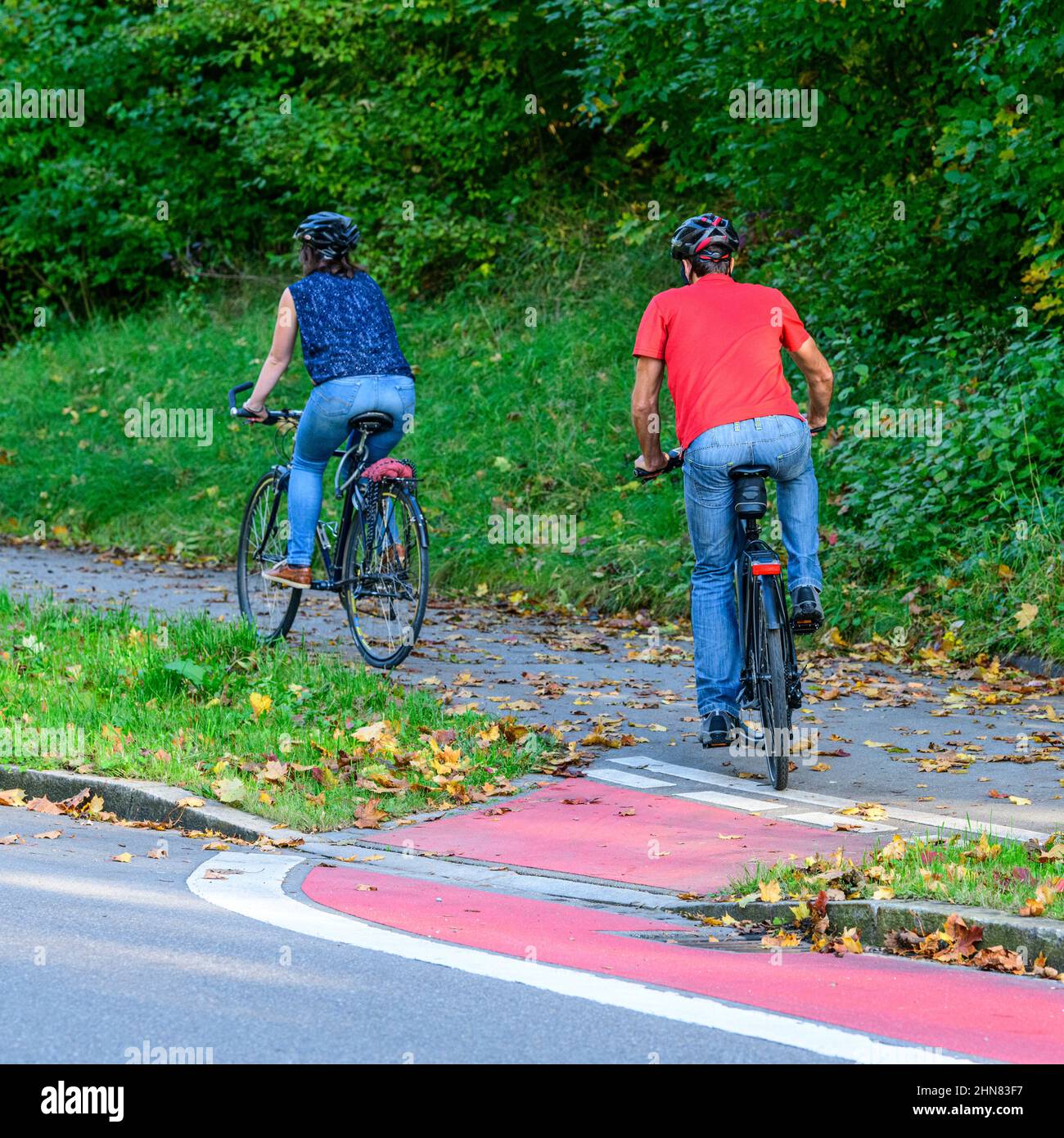 Cyclists using bicycle road in urban area Stock Photo - Alamy