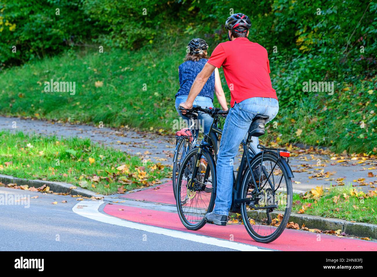 Cyclists changing from the cycle path to a combined cycling road and ...