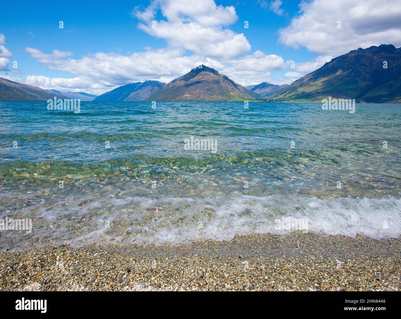 Mesmerizing view of the sea with mountains and cloudy sky Stock Photo ...