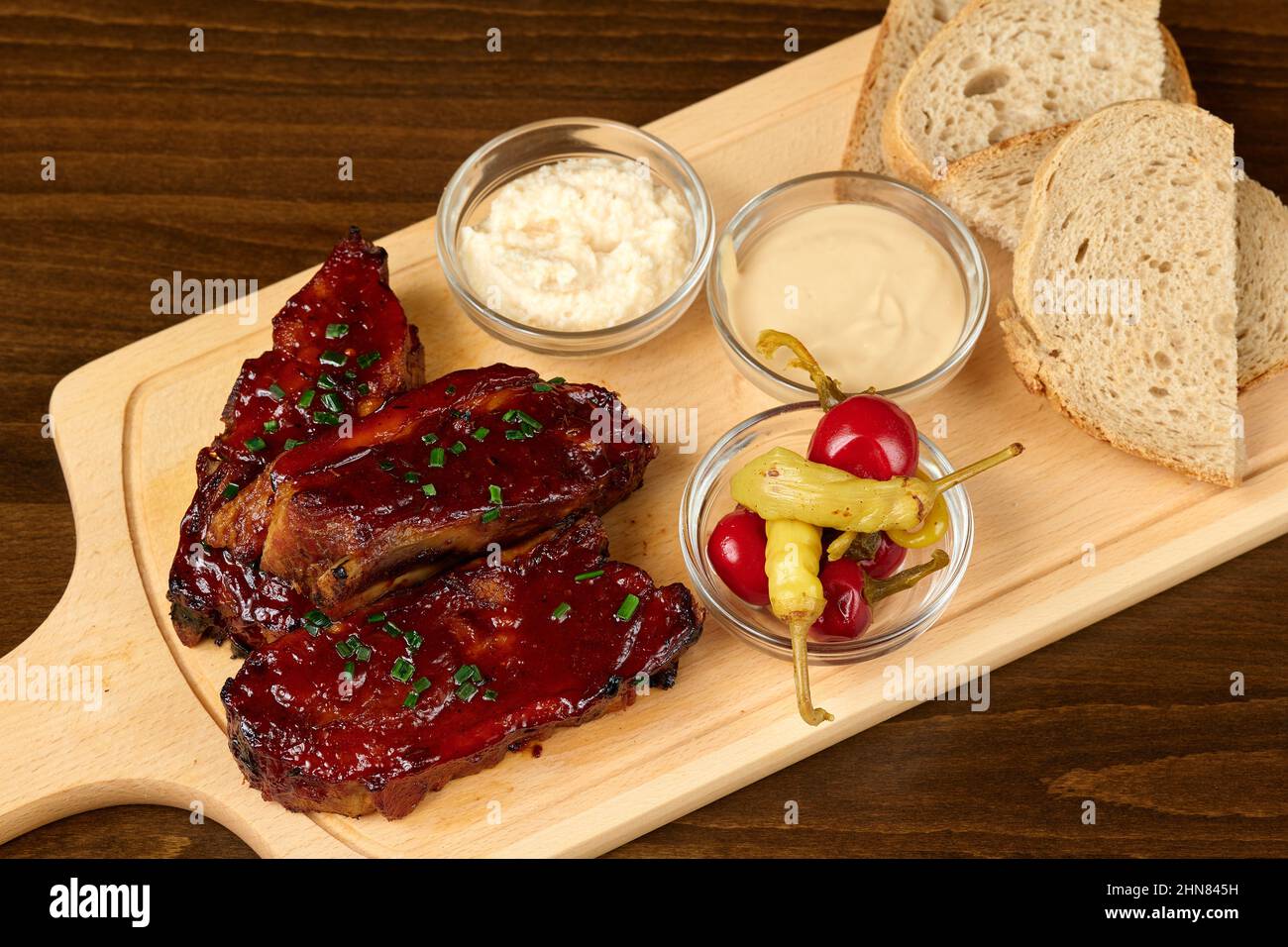 High angle shot of a gourmet board with wings, sauce, and bread Stock ...