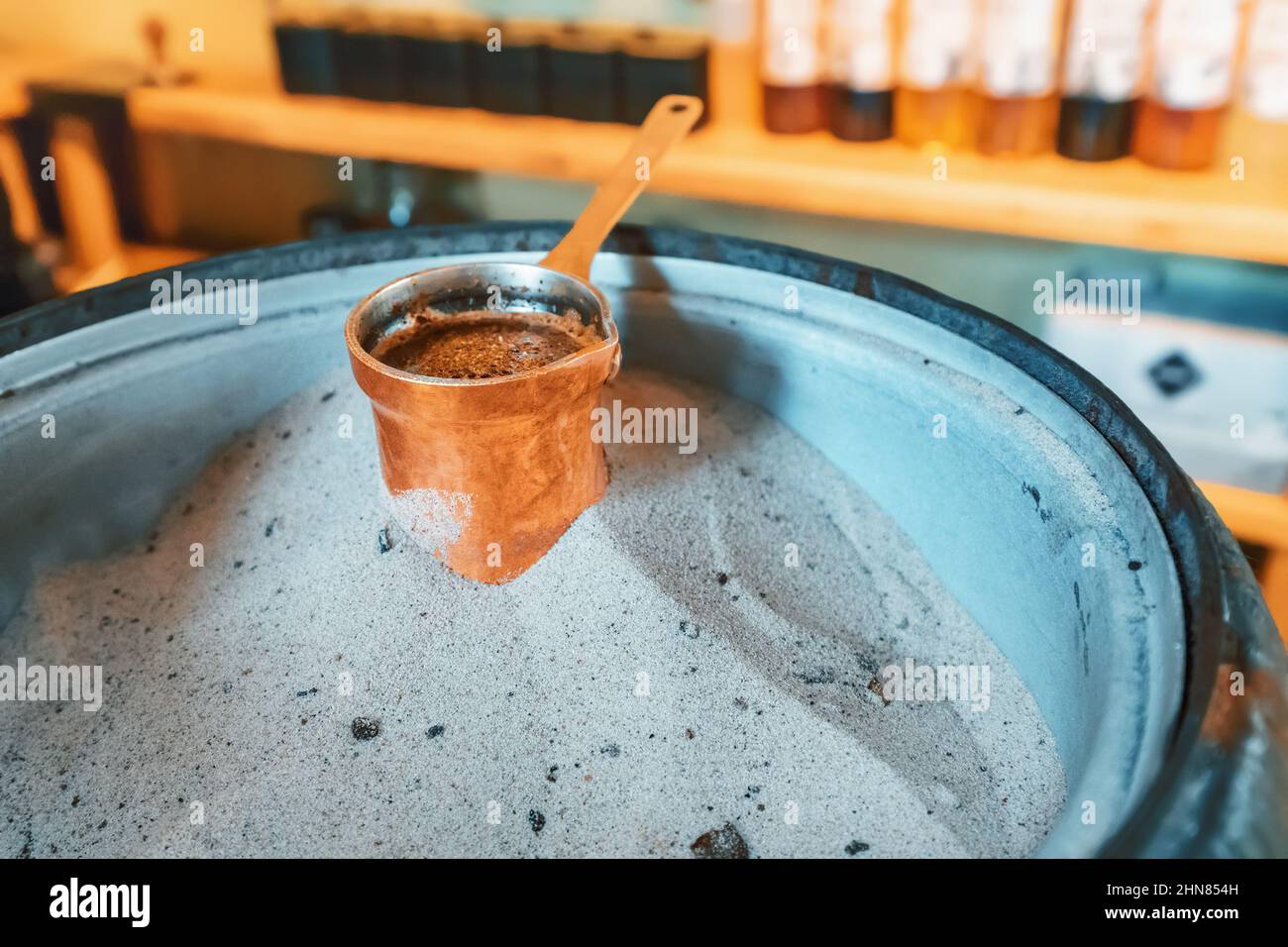 Cooking fresh coffee in cezve on hot sand according to an ancient ...