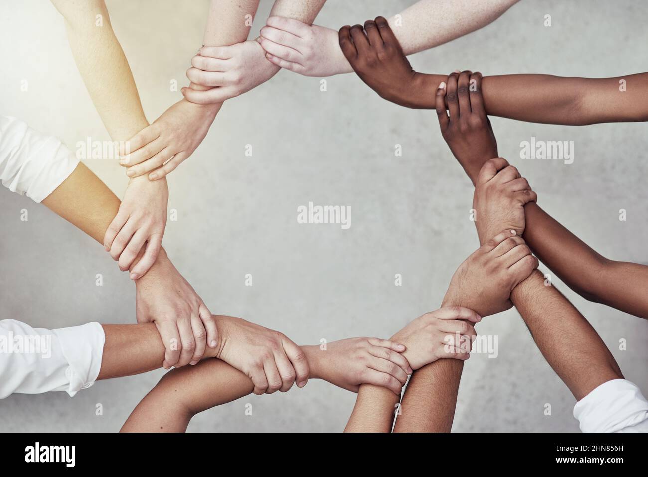 We are more powerful together. Shot of a group of hands holding on to ...