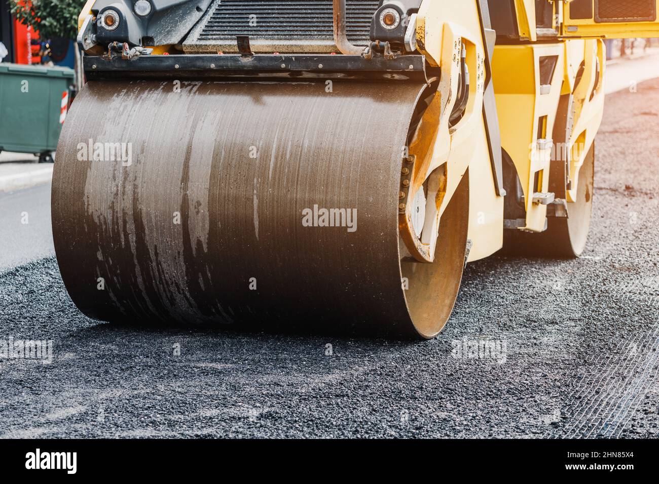 The roller paver levels the asphalt during the construction of the ...
