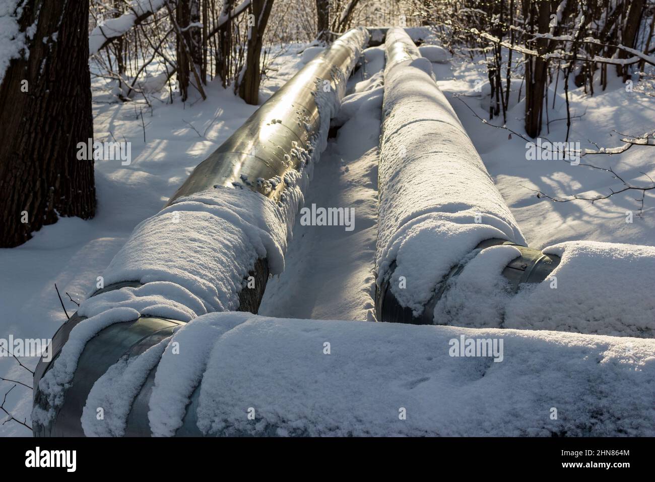 Large pipes with hot water laid outdoors above the ground, pipes ...