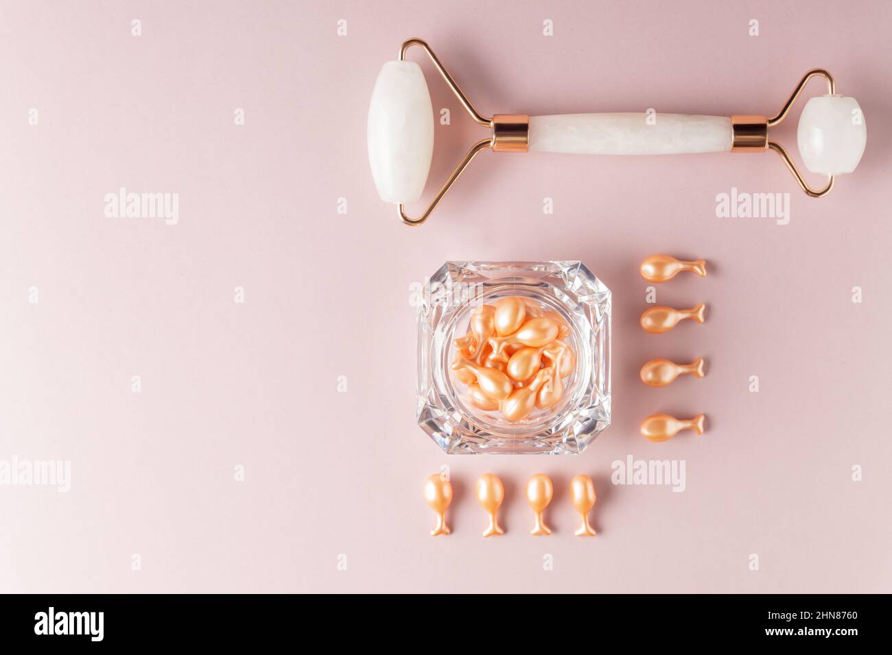 Pink quarts face roller and single dose serum capsules in a package ...