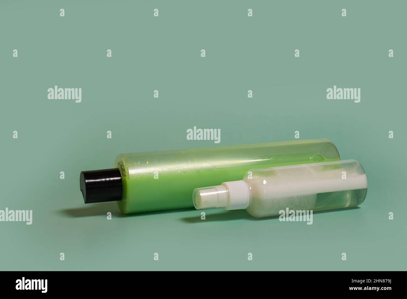 Plastic containers with shampoo and hair firming agent Stock Photo - Alamy