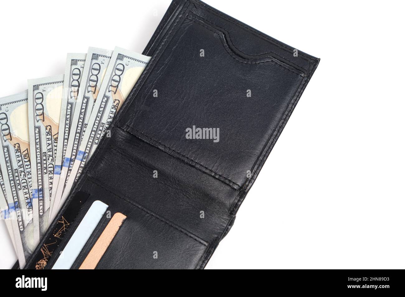 Black leather wallet with stack hundred dollar bills and bank cards on ...