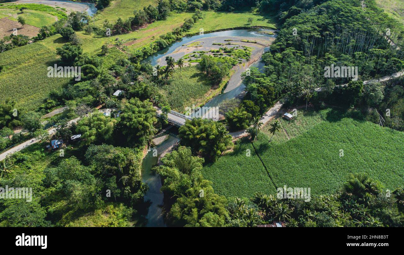 Aerial view of a bridge over a river in a rural area of the Philippines ...