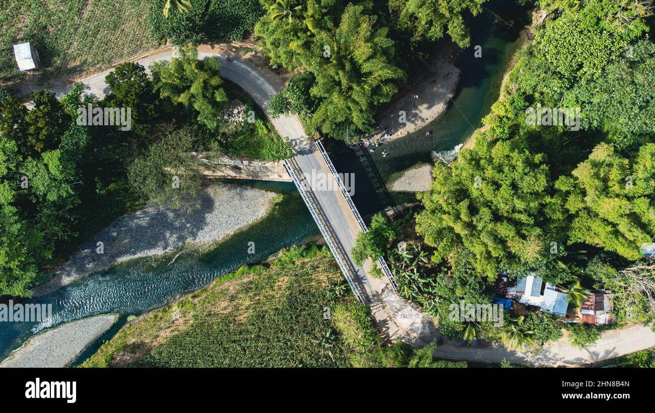 Aerial view of a bridge over a river in a rural area of the Philippines ...