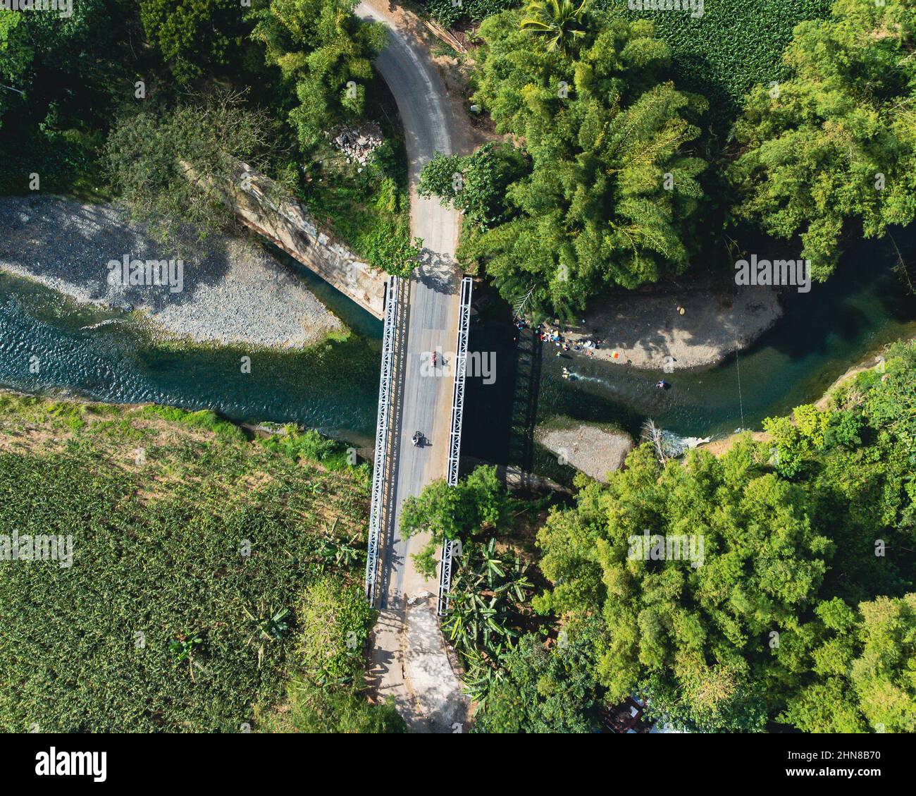 Aerial view of a bridge over a river in a rural area of the Philippines ...