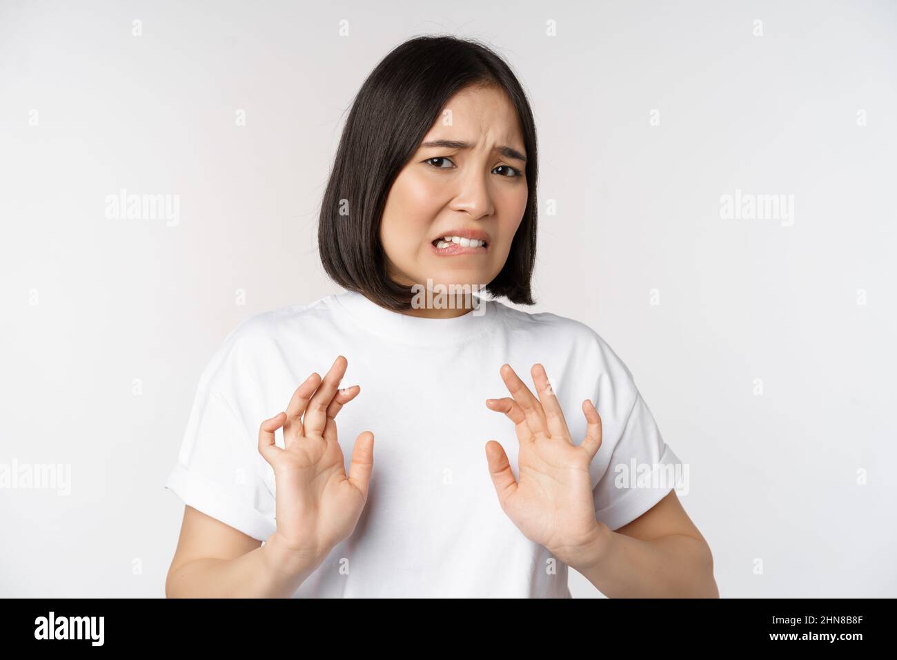 Disgusted asian woman rejecting smth, grimacing from dislike and ...