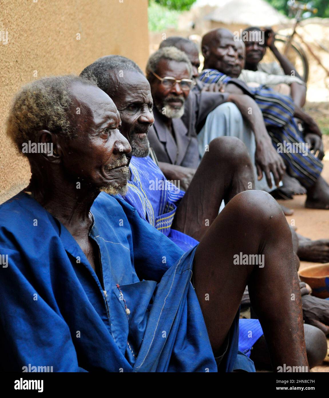 Elderly Mossi men sitting together in the center of a village in ...