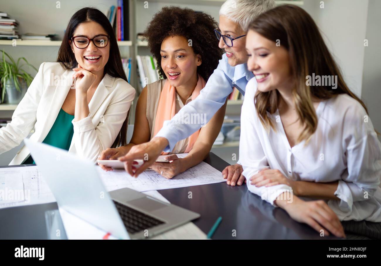 Group of happy successful women colleagues working together on meeting ...