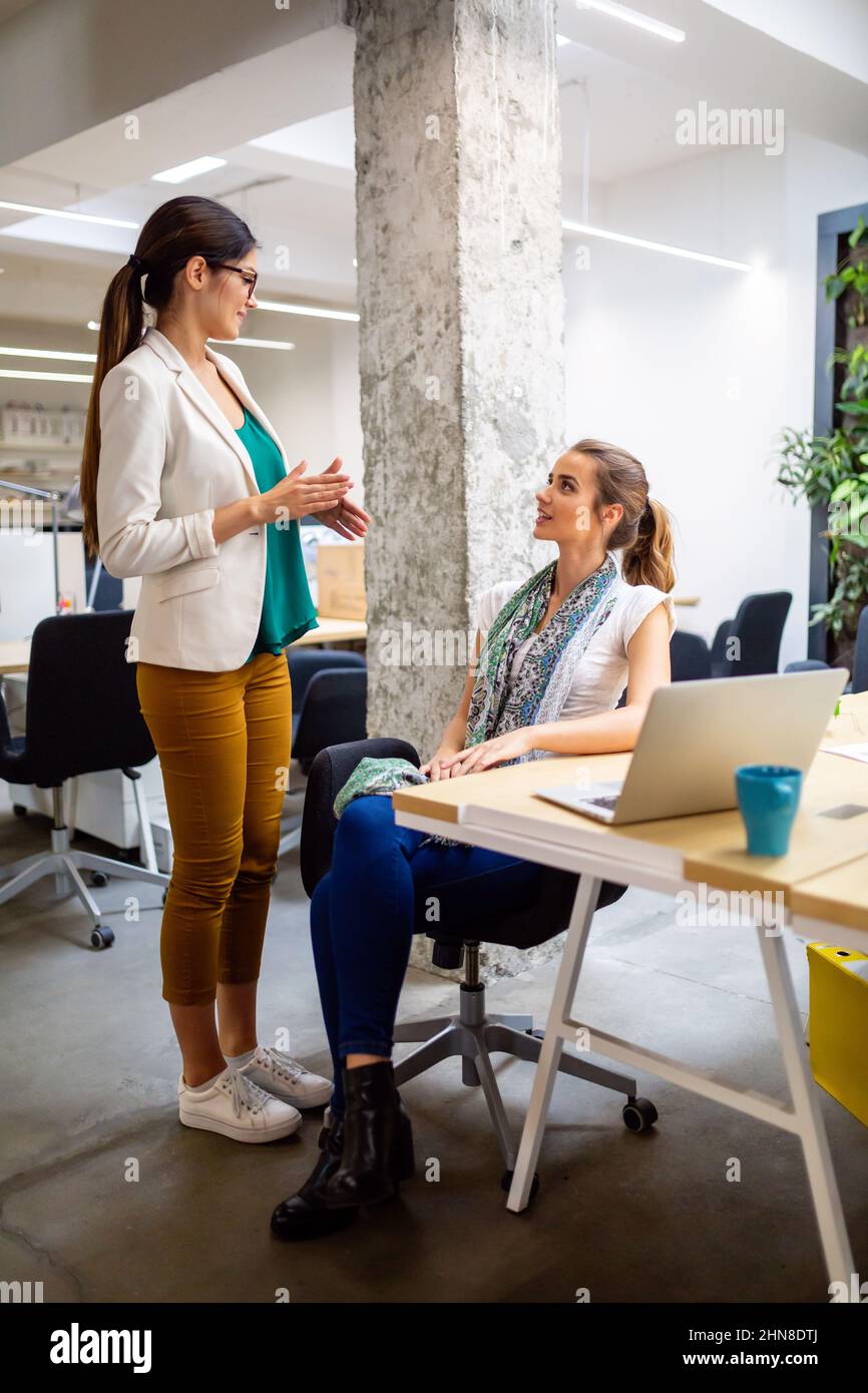 Attractive businesswoman having fun conversation with colleague during ...
