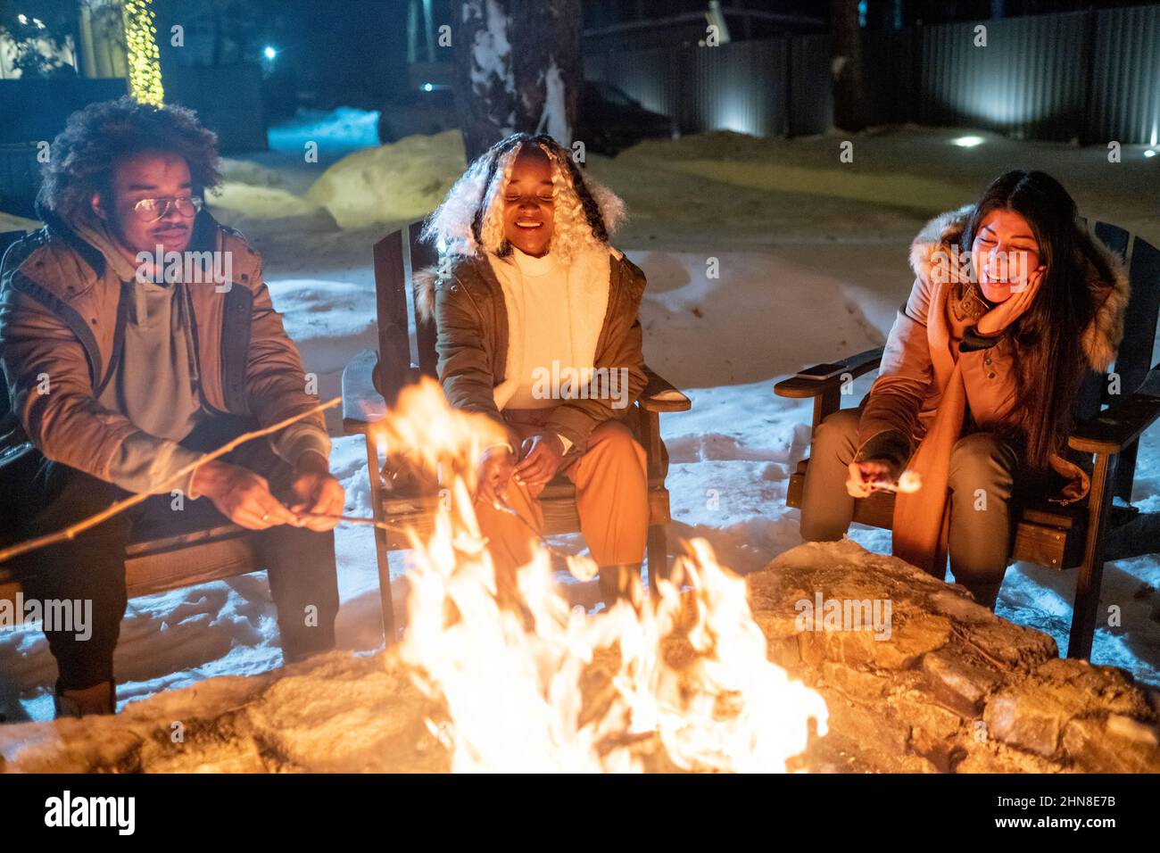 Happy friends talking to each other till late evening while sitting ...