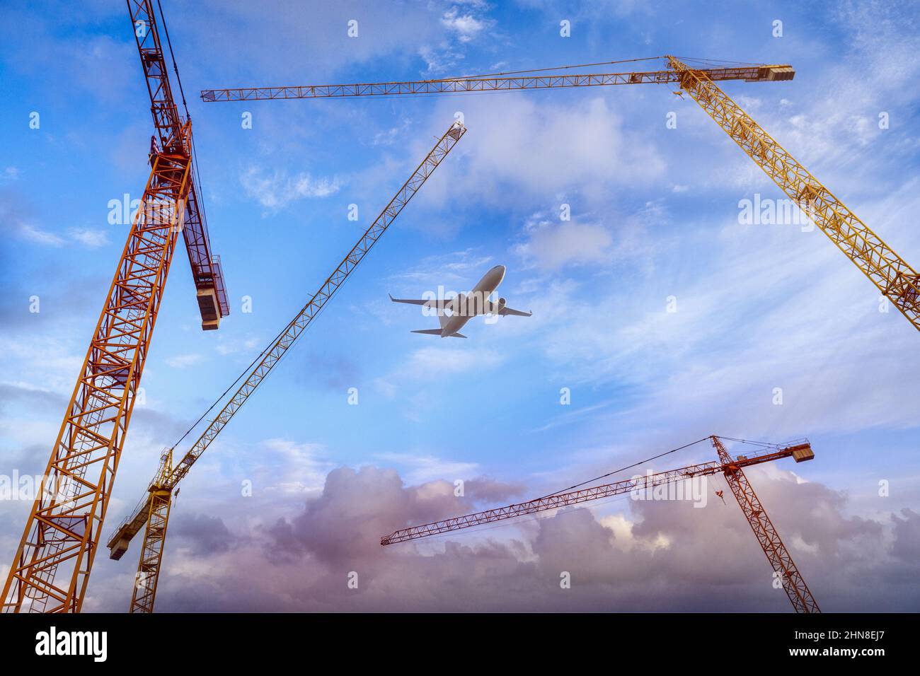 View of the plane flying above the construction cranes. Barcelona ...