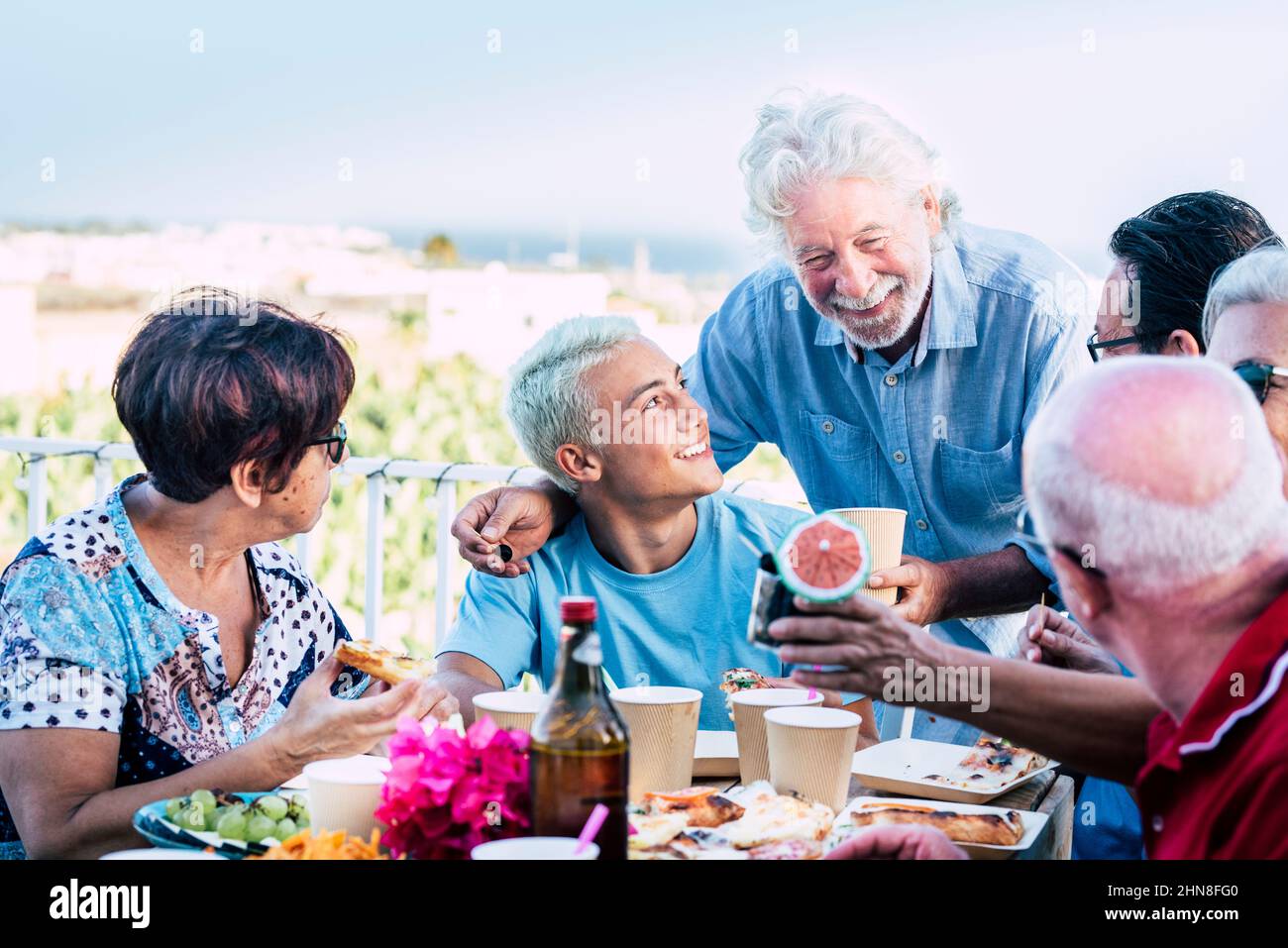 Mixed generations family enjoy together food and celebration outdoor ...