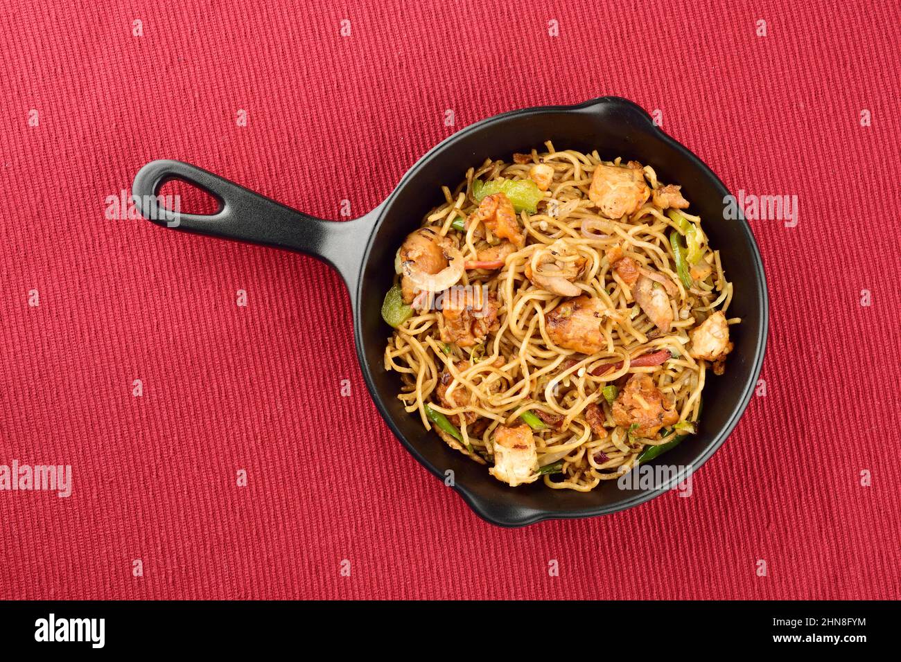 top view of chicken chow mein in plate on red dining mat Stock Photo ...