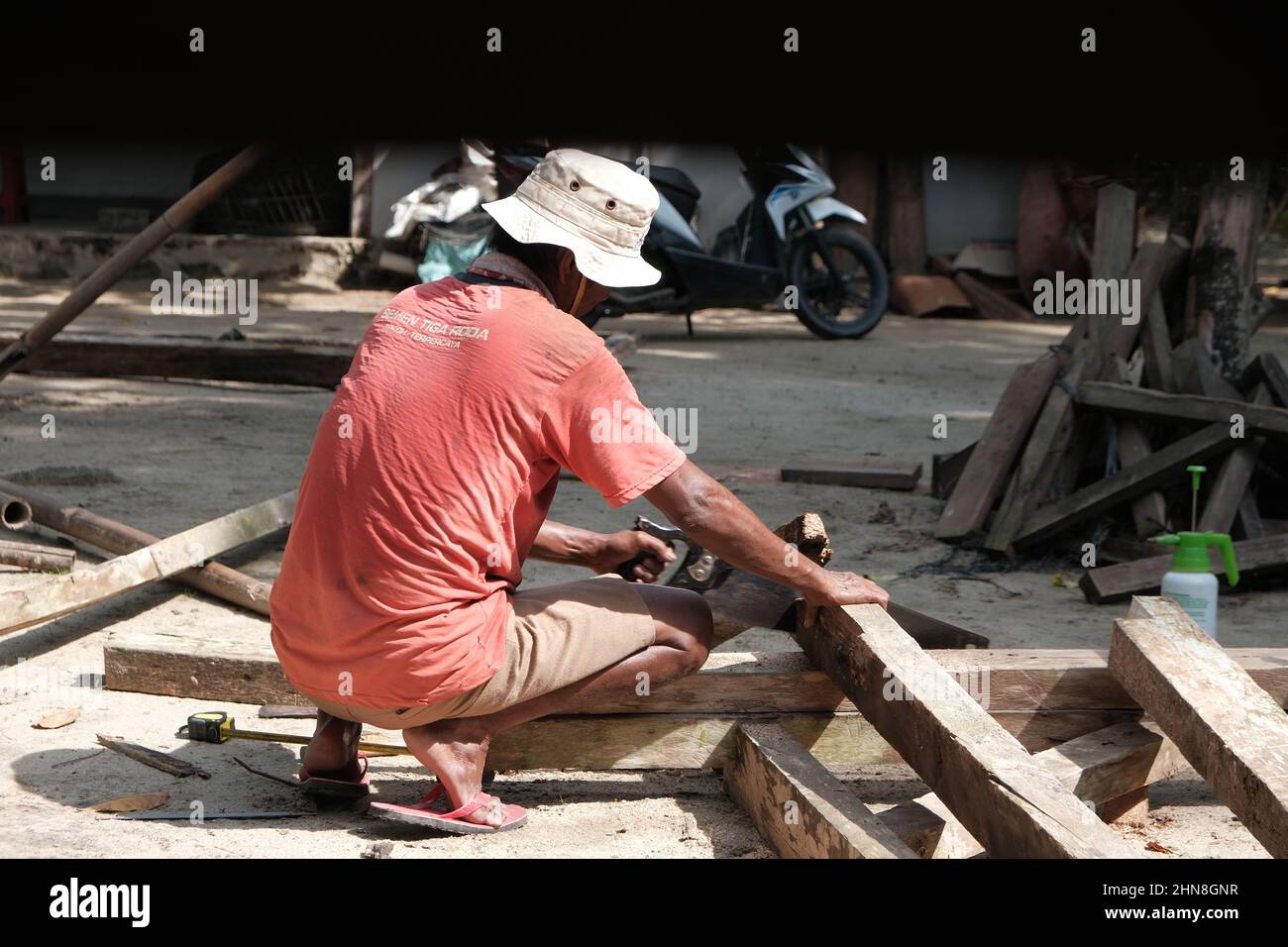 Lampung, Indonesia, February 11 2022- An Indonesian carpenter builds a ...