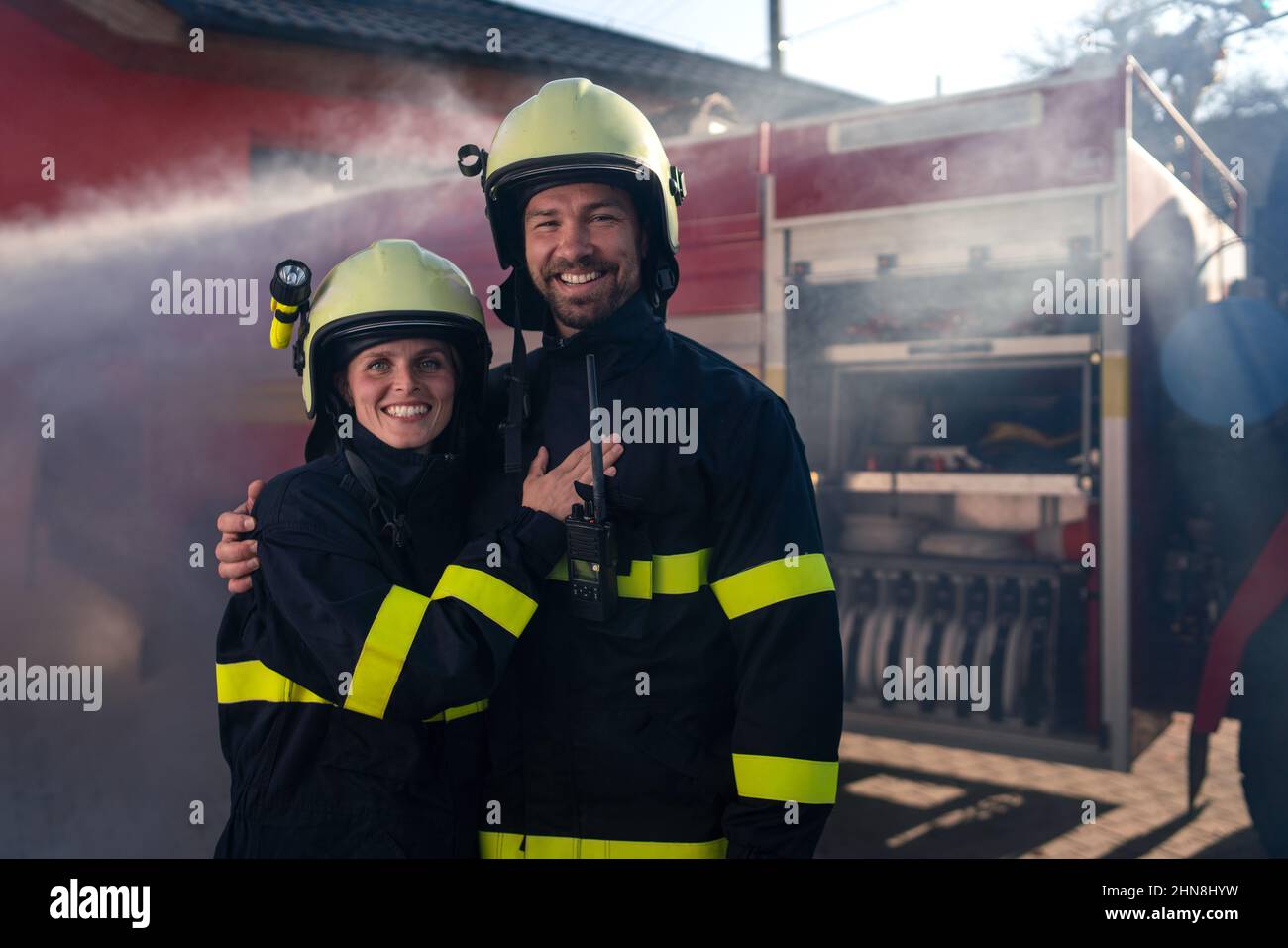 Happy firefighters man and woman after action looking at camera with ...