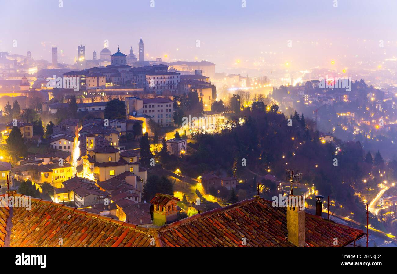 Illuminated Bergamo upper city in misty winter twilights, Italy Stock ...