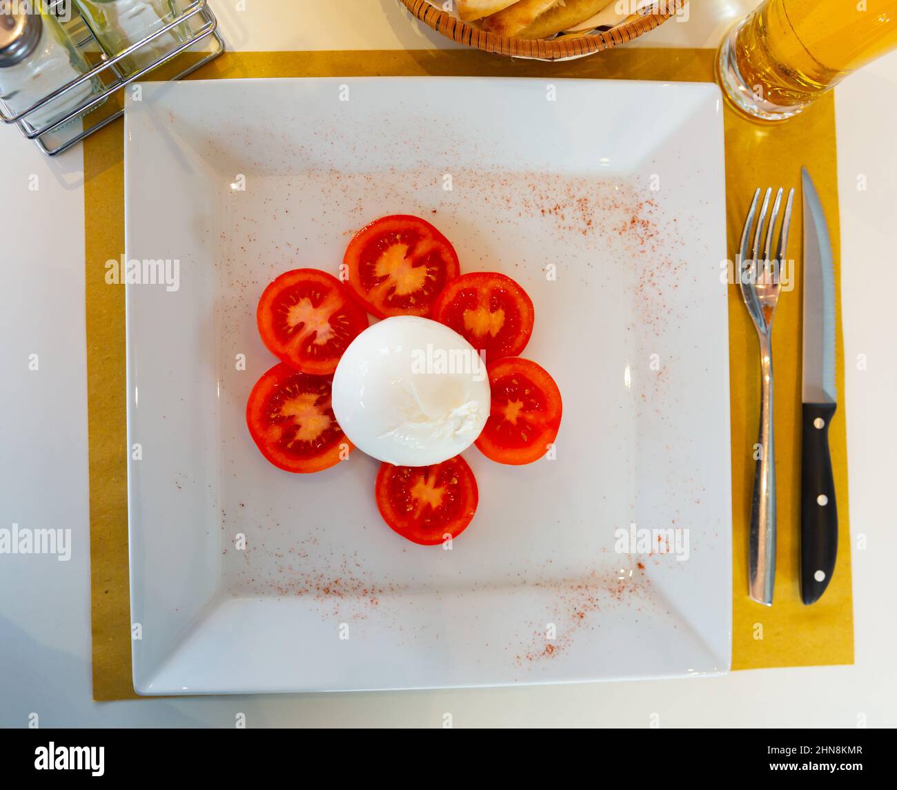 Italian snack Buratta with tomatoes Stock Photo - Alamy