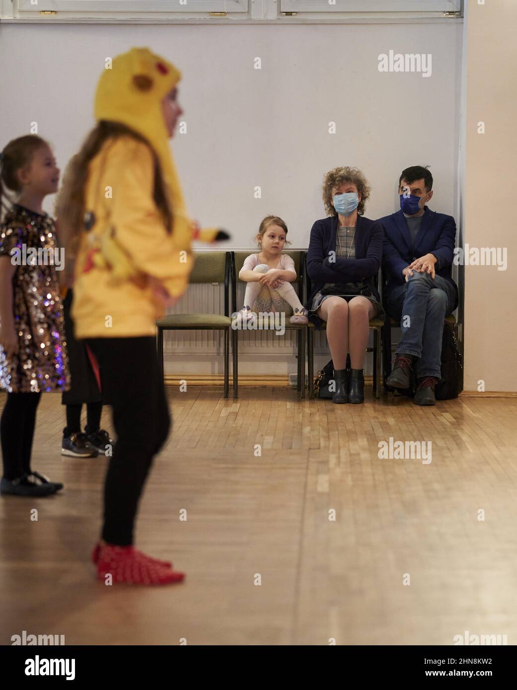 Vertical shot of the male, female and the kid wearing masks and ...