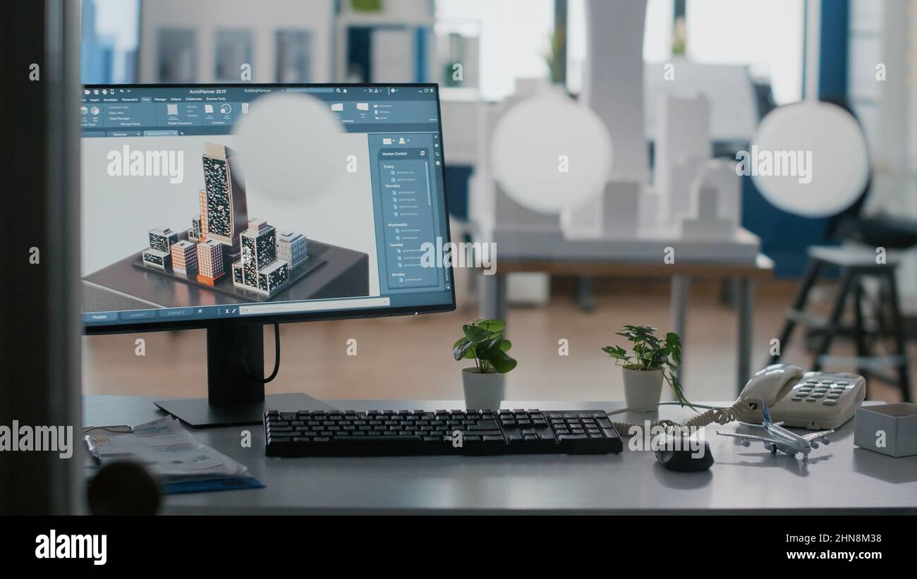 Close up of monitor with 3d building and construction layout on table ...