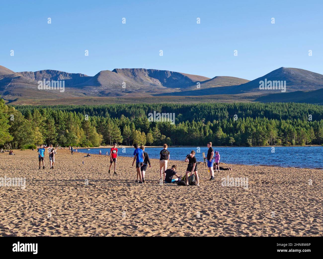 Boys playing on the sandy beach at Loch Morlich, Cairngorms, Scottish ...