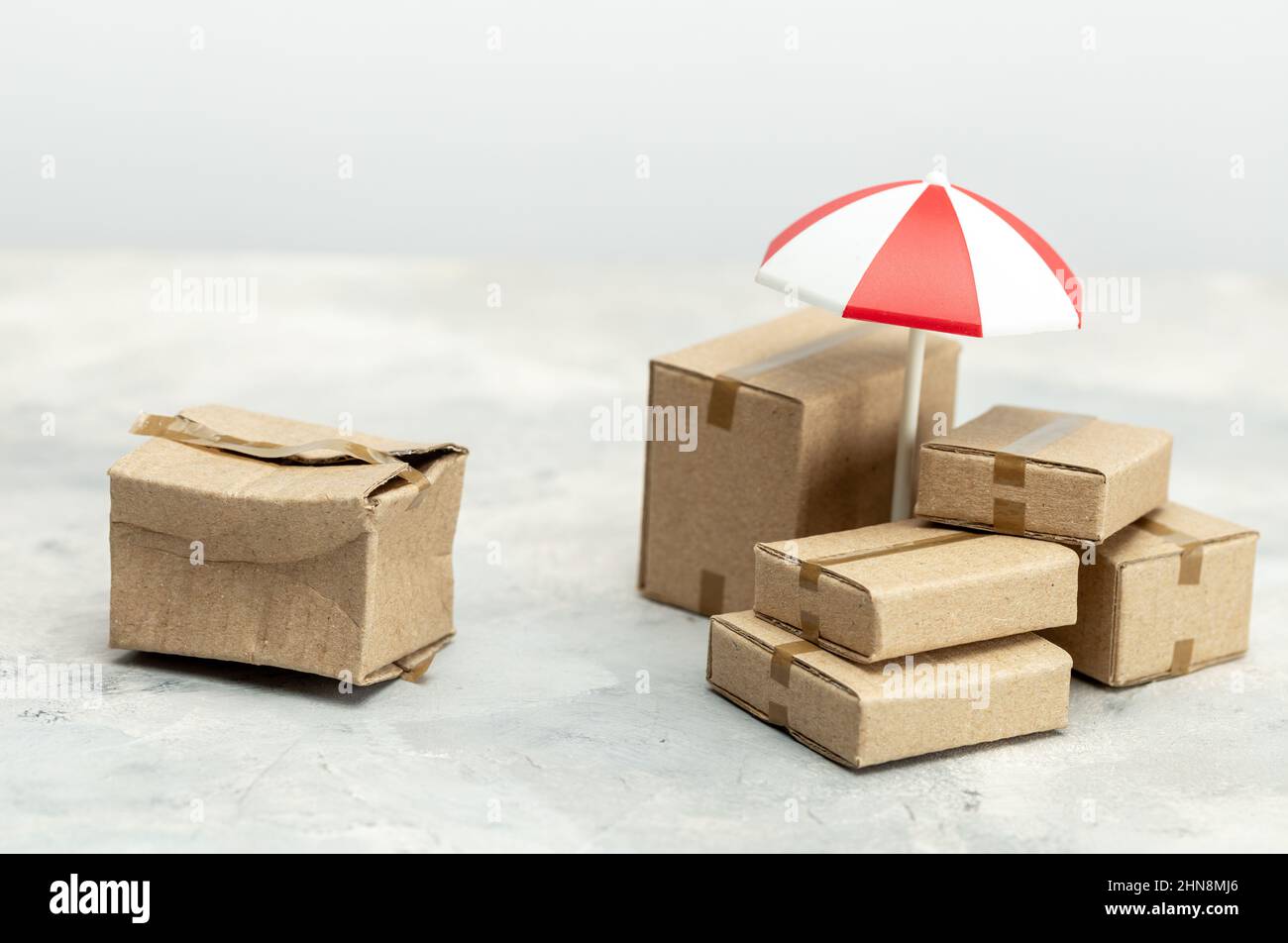 Delivery insurance. Crumpled and broken box with Cardboard boxes ...