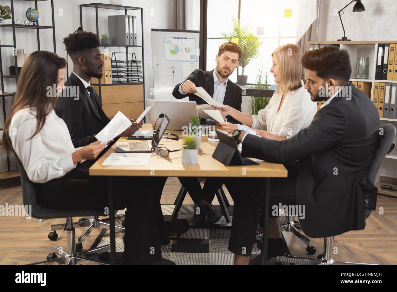 Group of five multiracial business people in formal clothes having ...