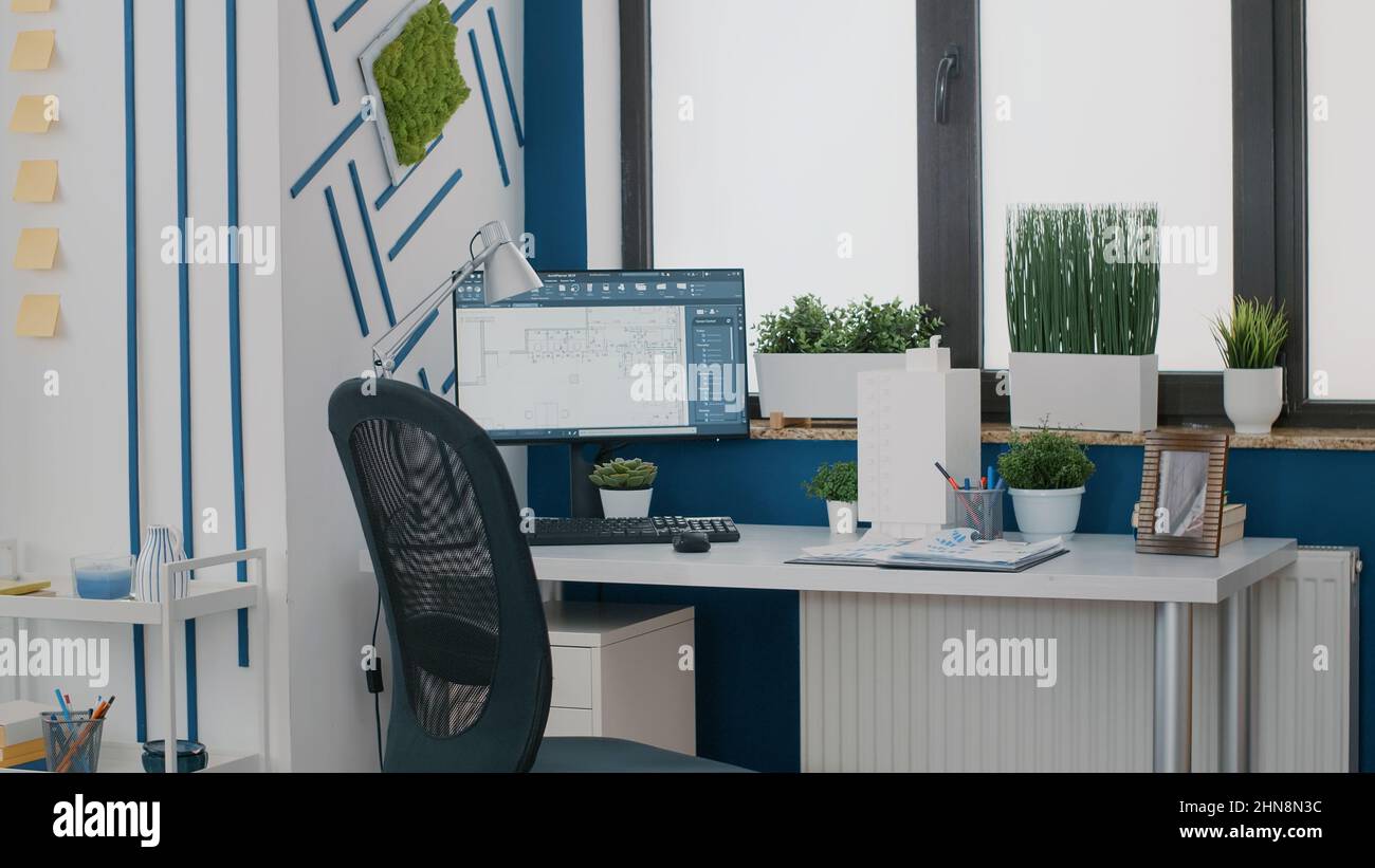 Close up of computer with digital blueprints plans on desk in ...