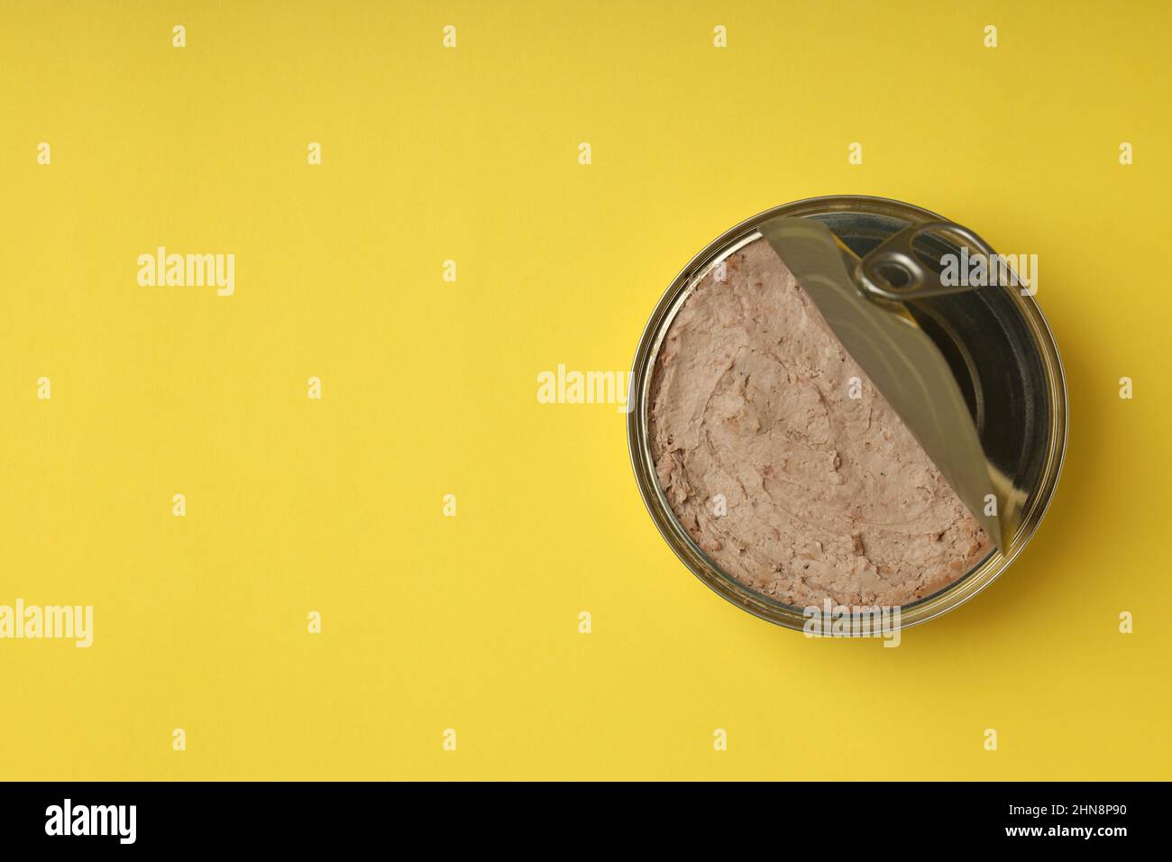 Tin of pate on yellow background, space for text Stock Photo - Alamy