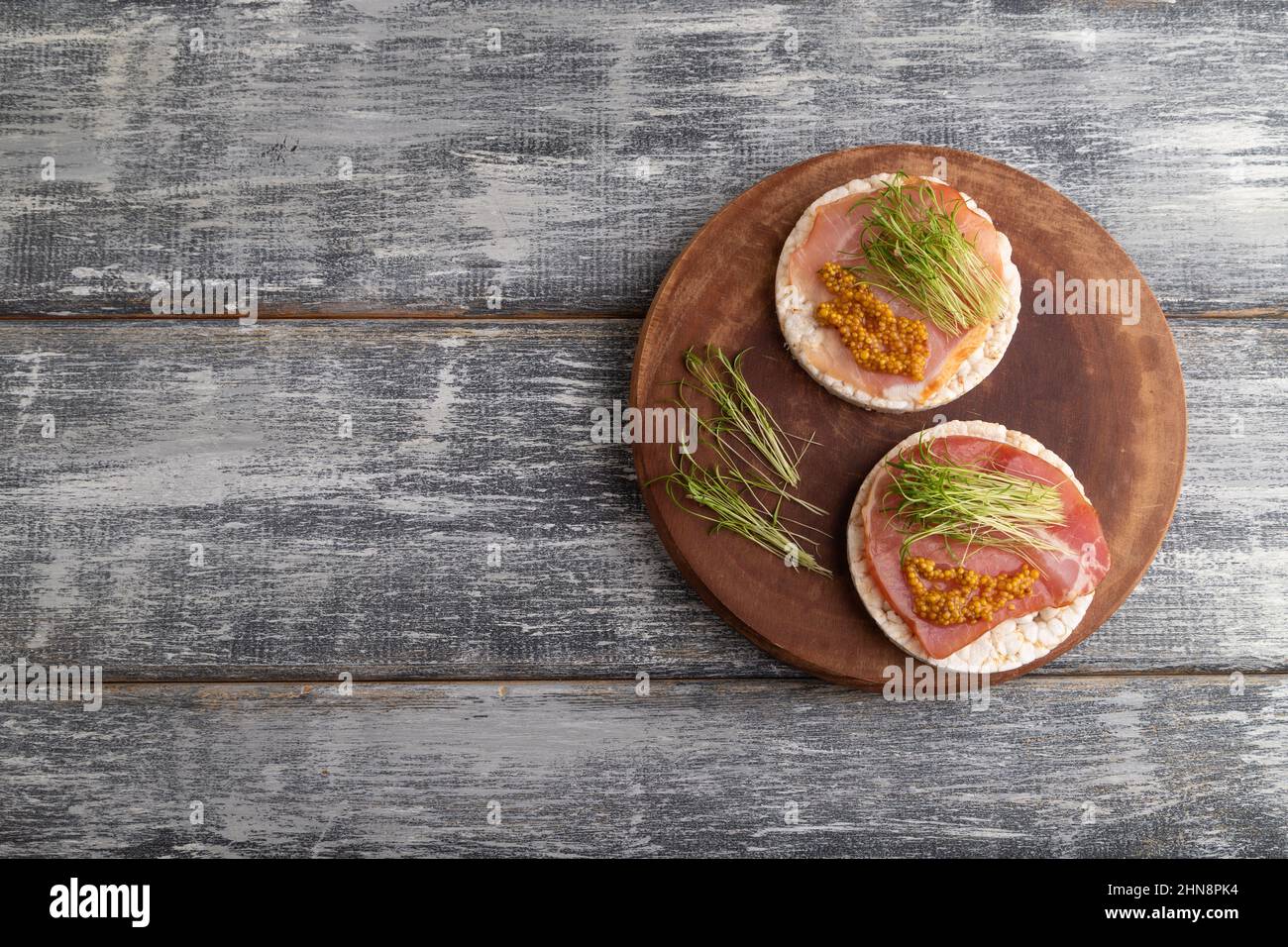 Puffed rice cake sandwiches with jerky salted meat, carrot microgreen ...