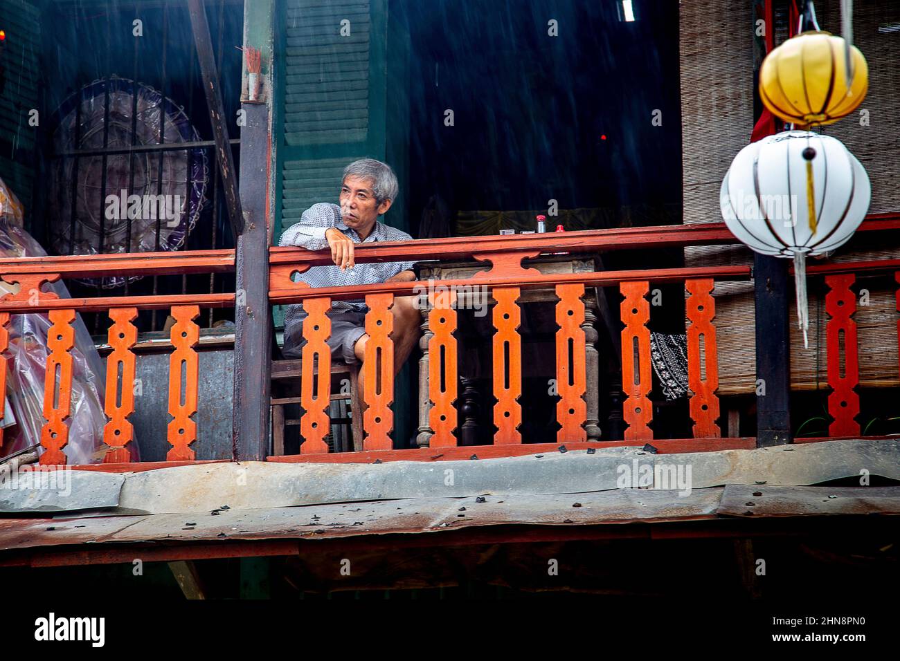 Man hanging from balcony hi-res stock photography and images - Alamy