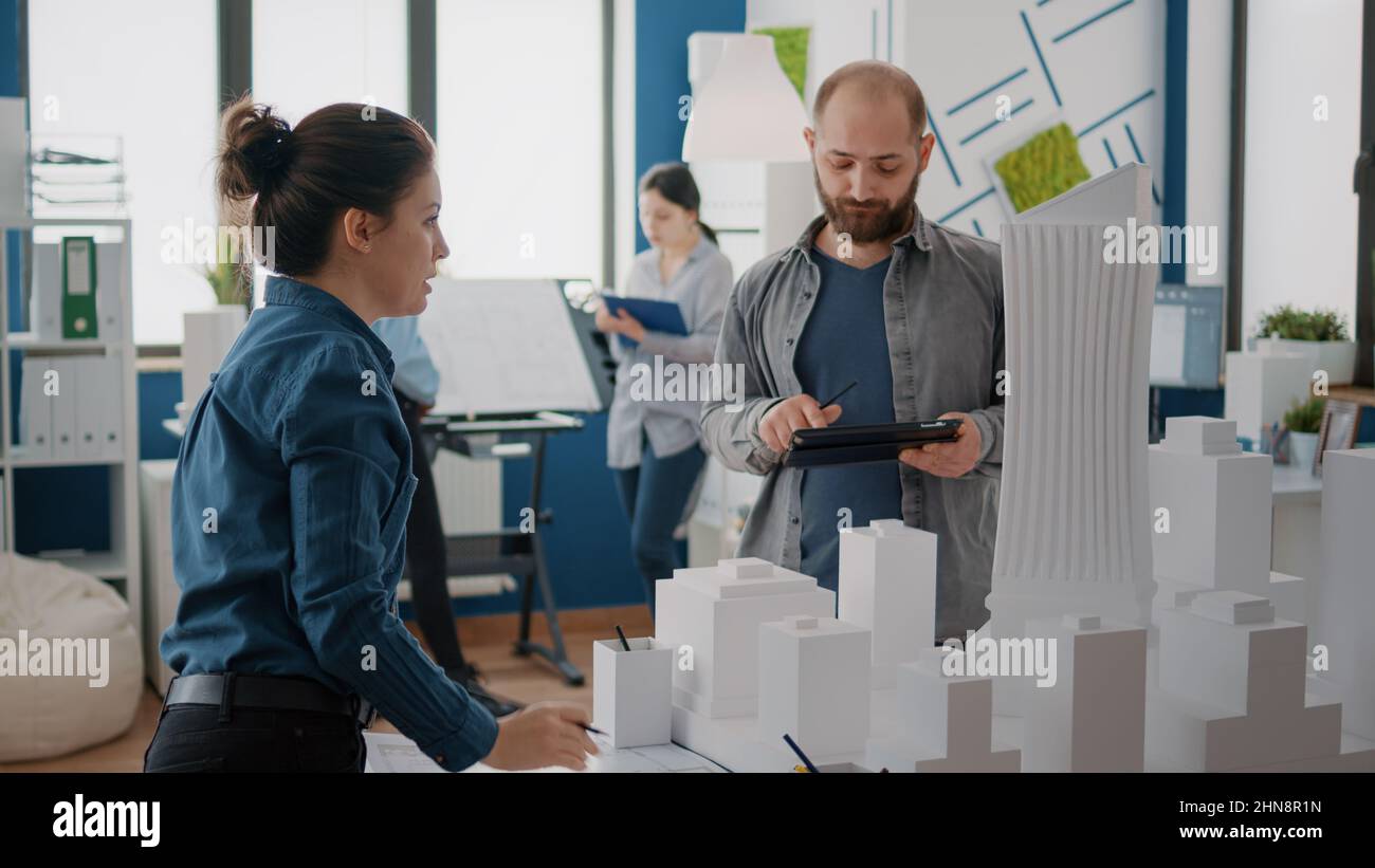 Man and woman doing teamwork to plan construction layout with digital ...