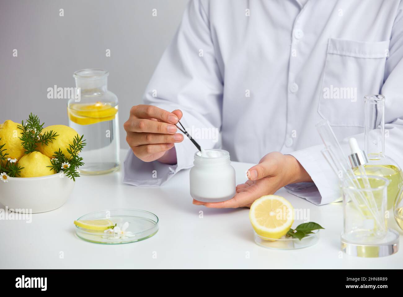 Lemon extract with sliced lemon transparent podium in laboratory ...